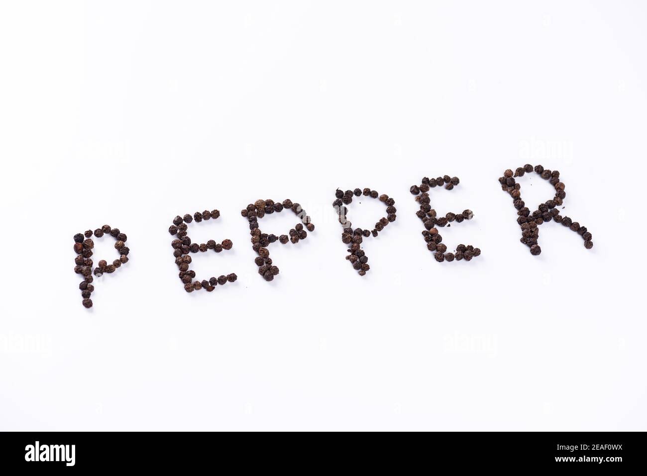 Black pepper writing isolated on white background Stock Photo - Alamy