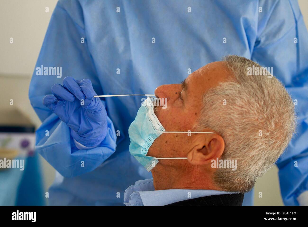A medical worker wearing a personal protective equipment suit ( PPE ...