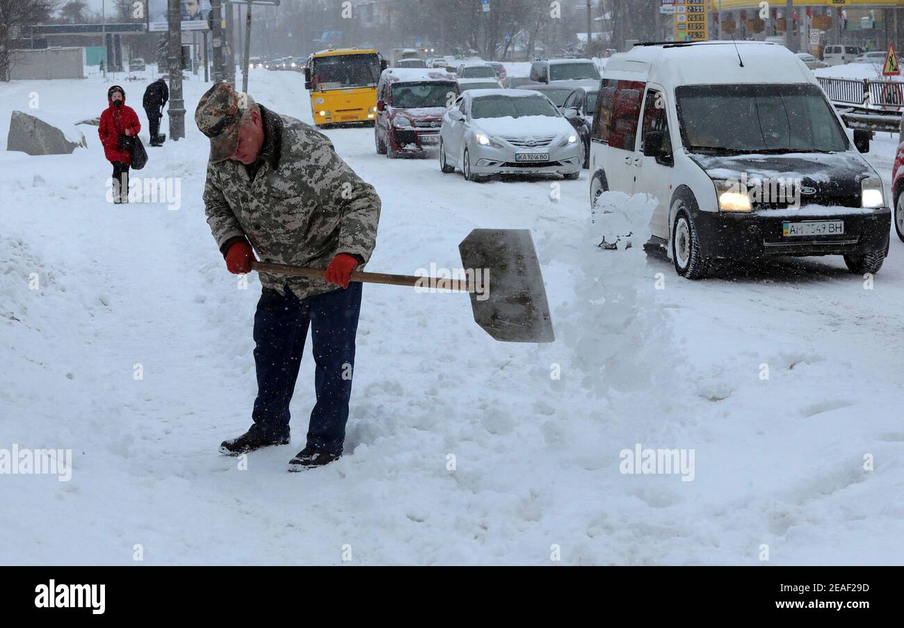 Non Exclusive: KYIV, UKRAINE - FEBRUARY 9, 2021 - A man spades away ...