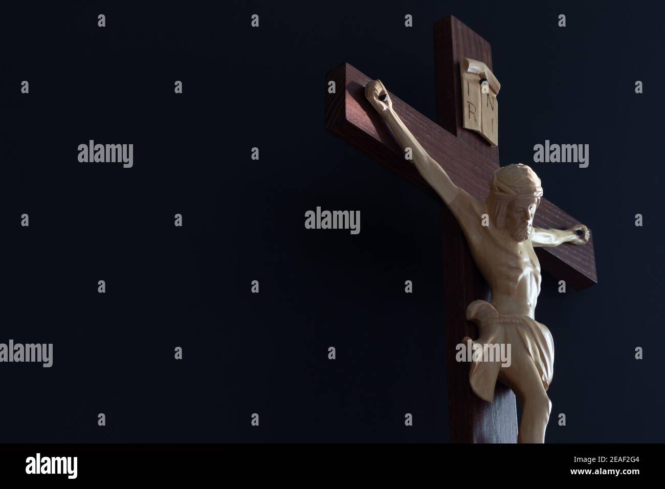 wood crucifix cross with Jesus on black background with copy space ...