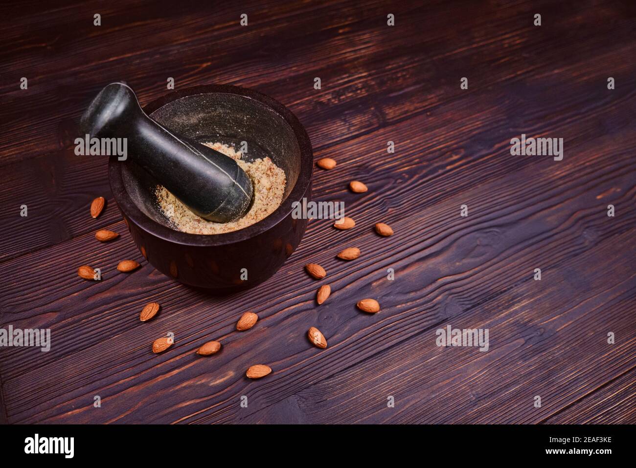 Grind nuts in a mortar. Ingredients for cooking, copy space ...