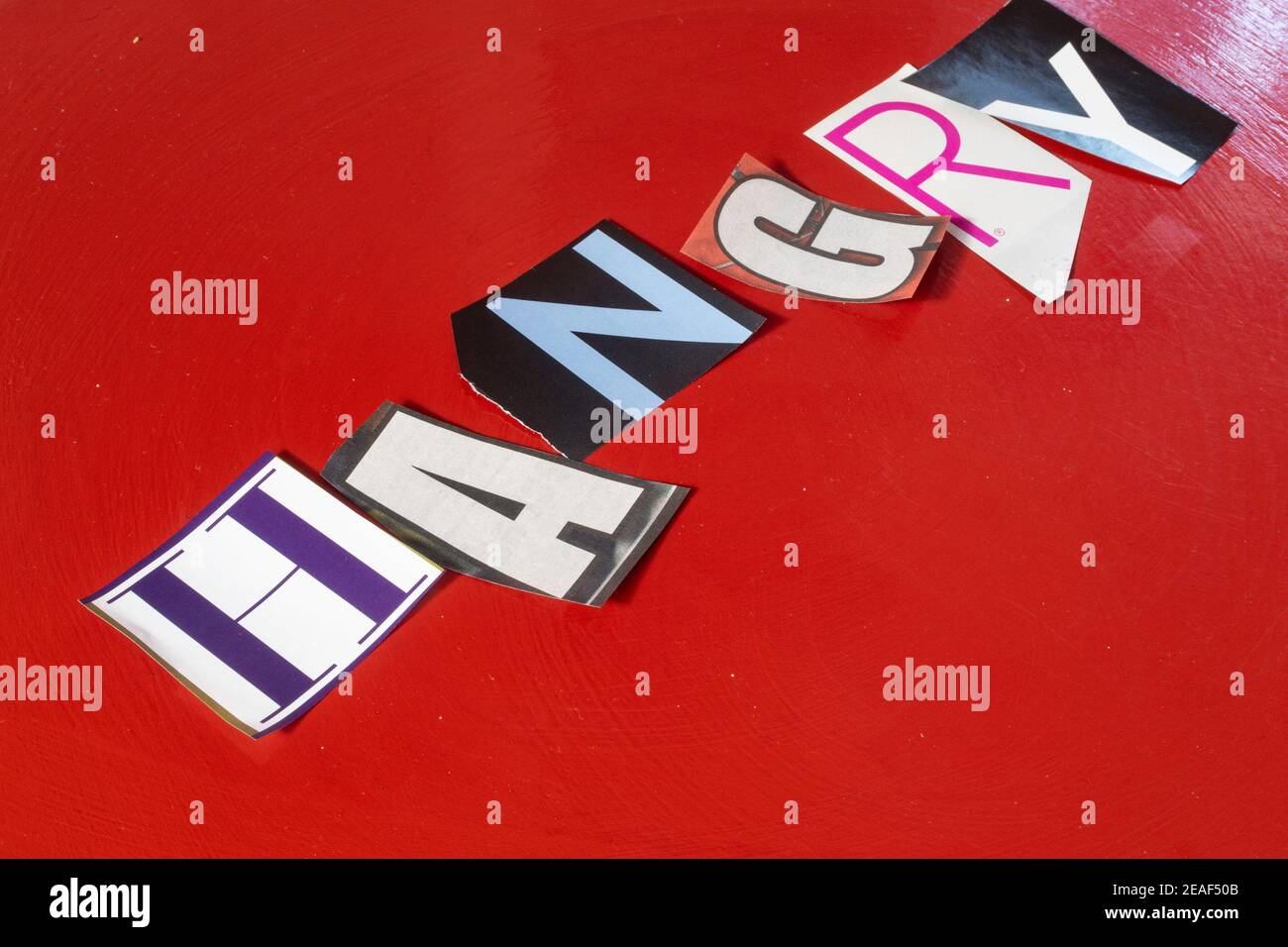 The Word "Hangry" using cut-out paper letters in the ransom note effect ...