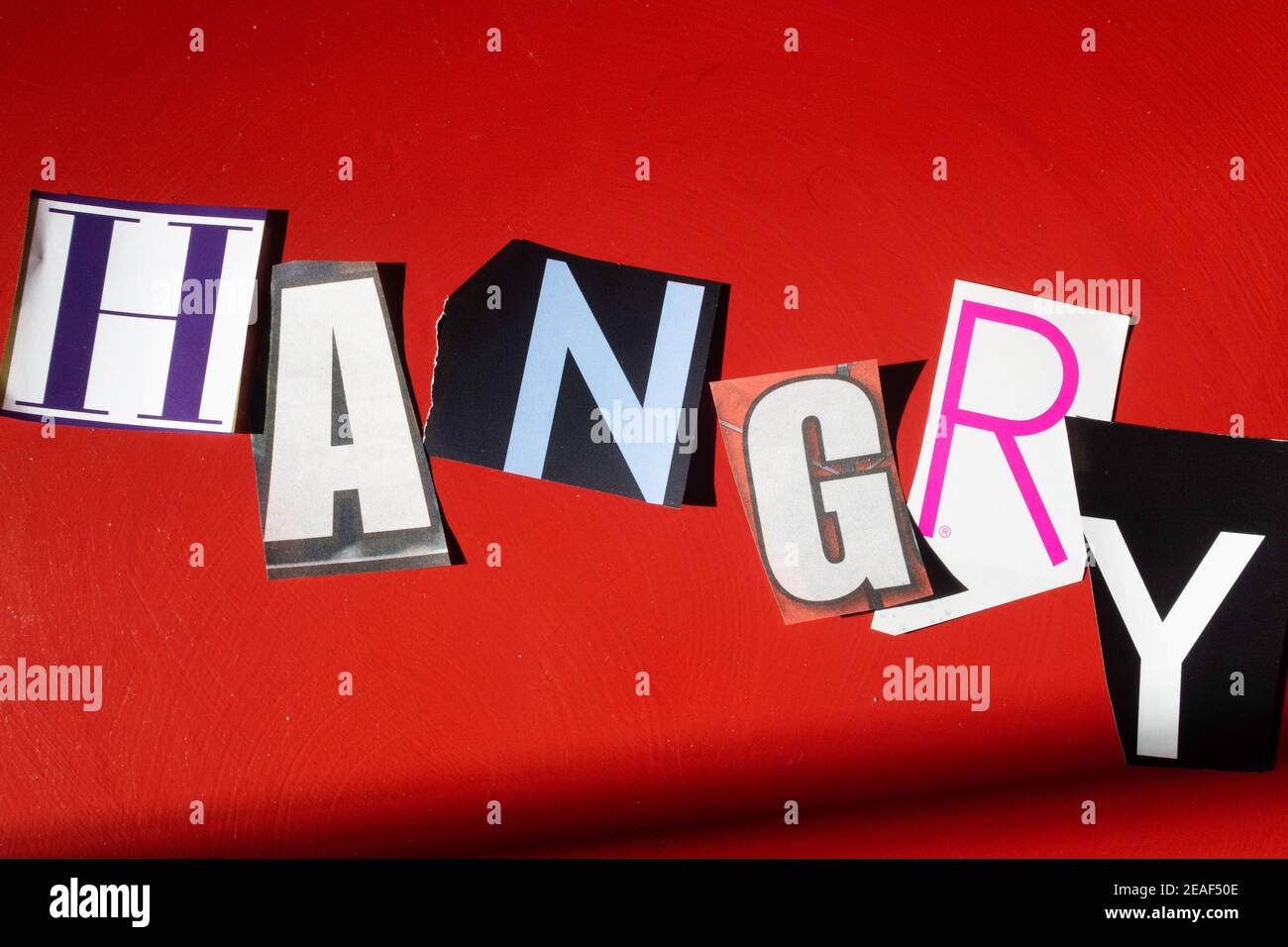 TheWord "Hangry" using cut-out paper letters in the ransom note effect ...