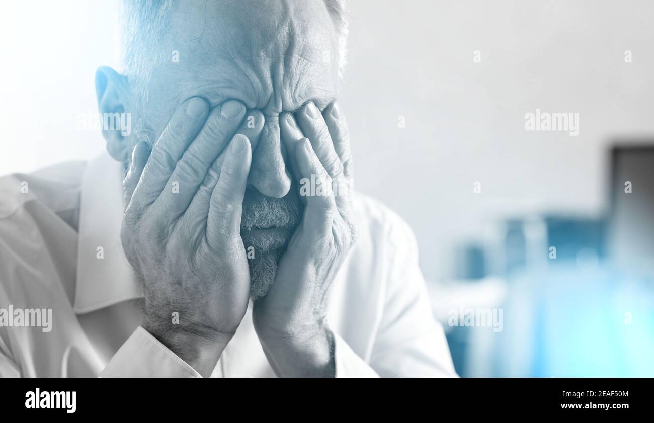 Portrait of a tired senior businessman; light effect Stock Photo - Alamy