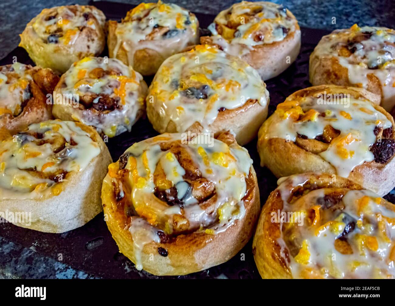 Chelsea buns with orange zest icing Stock Photo - Alamy