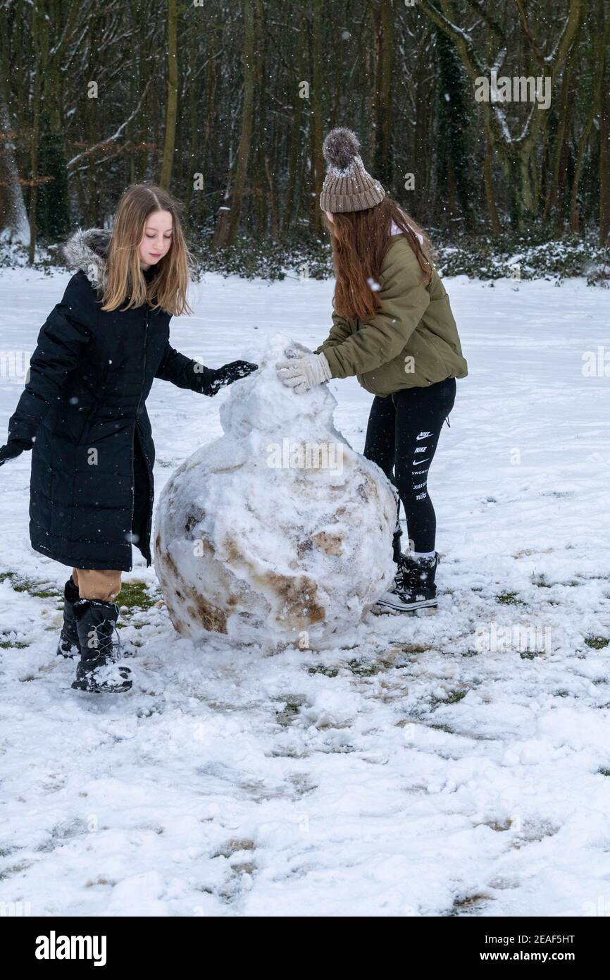 Girls making a snowman hi-res stock photography and images - Alamy