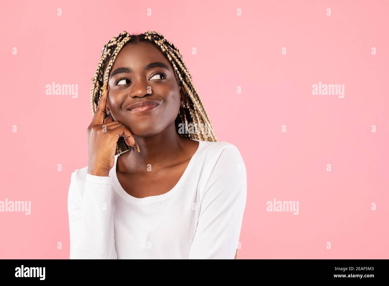 Pensive black woman thinking isolated on pink background Stock Photo ...