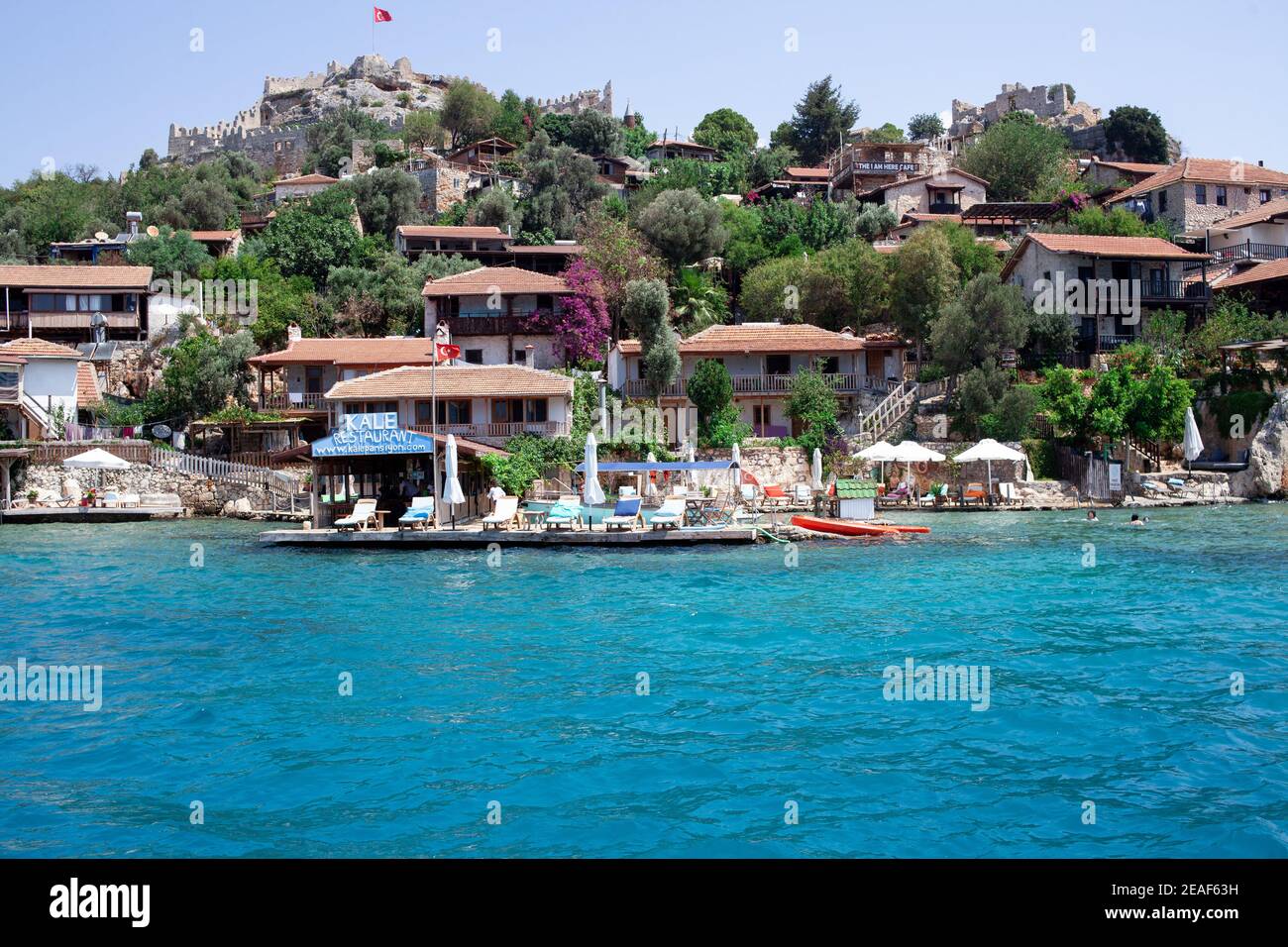 Ancient village of Simena with castle on mountain. Boat dock, beautiful ...