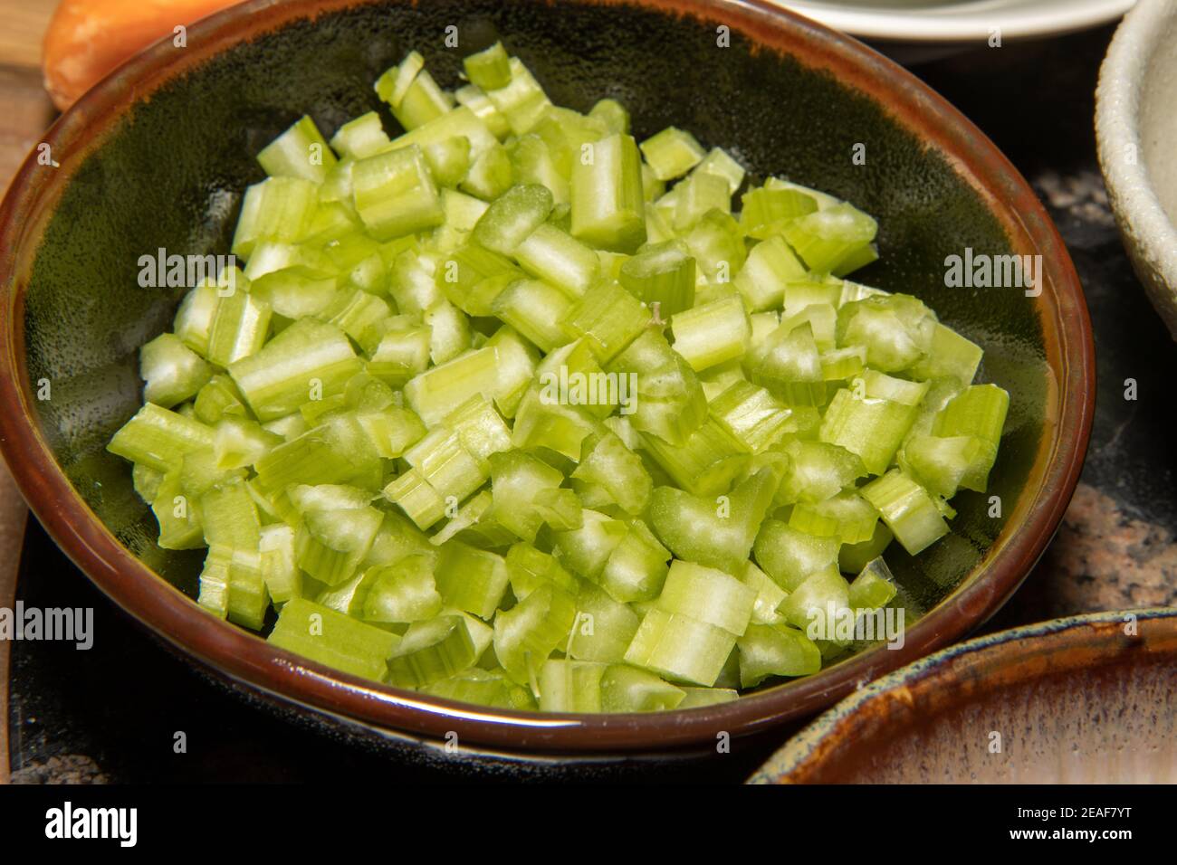 Cut celery in a bowl ready to be used as cooking ingredients Stock ...
