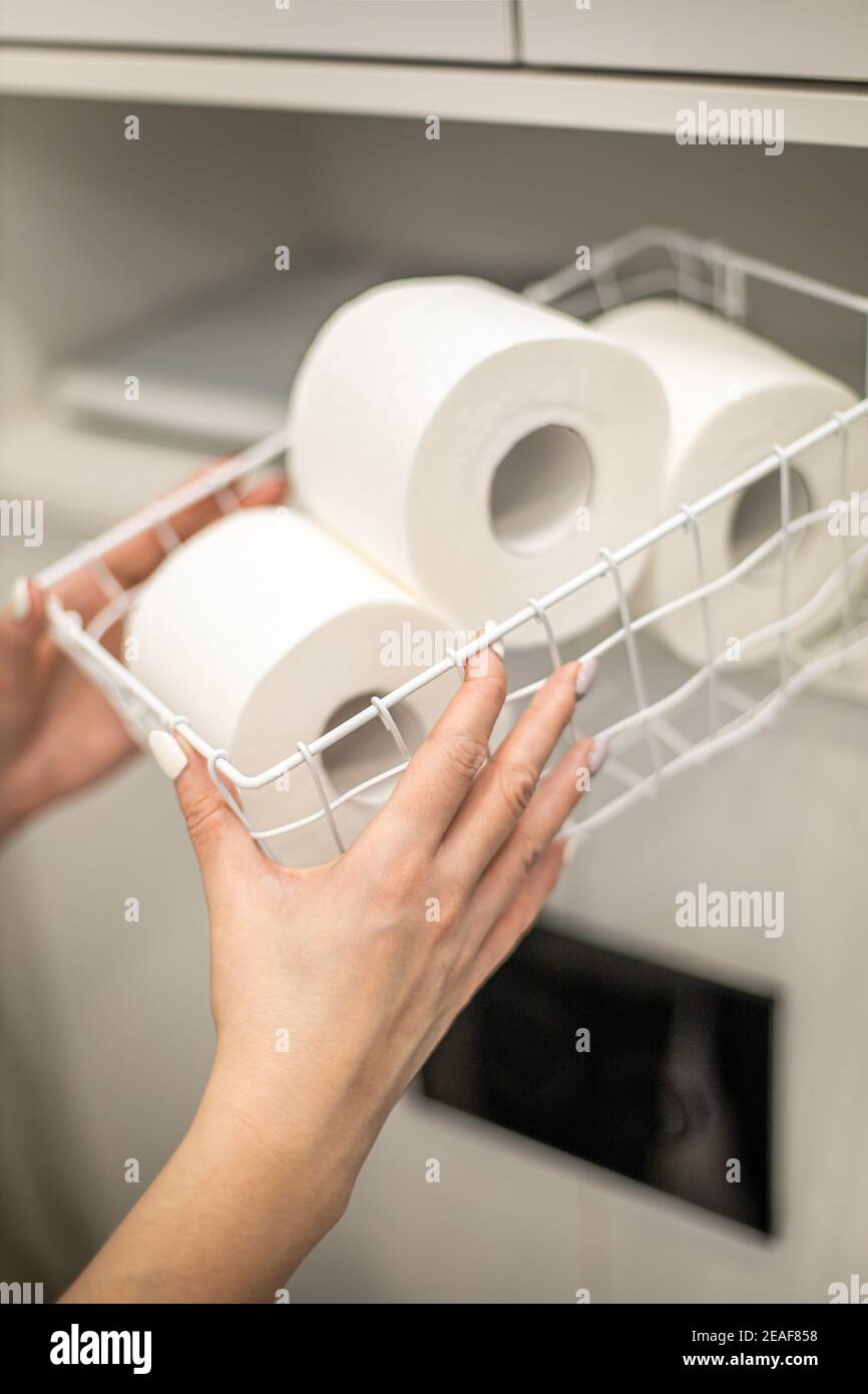 Young woman is organizing and placing metal mesh with toilet paper ...