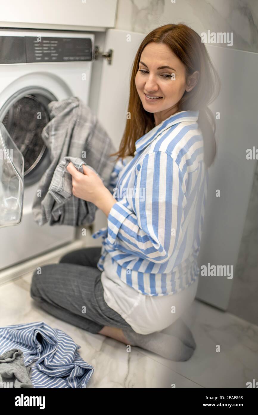 Woman sitting on washing machine hi-res stock photography and images ...