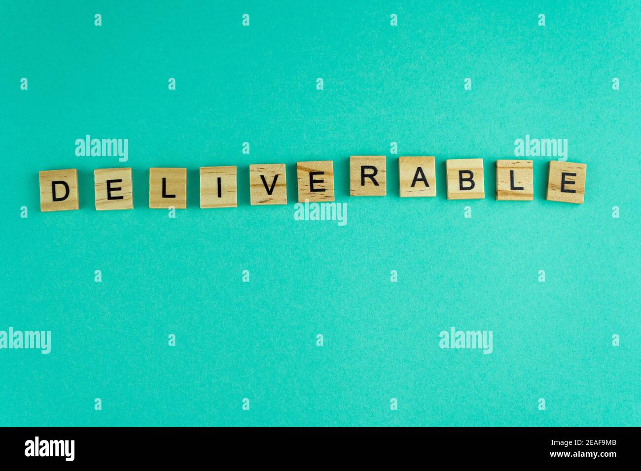 Word deliverable. The phrase is laid out in wooden letters. Top view ...