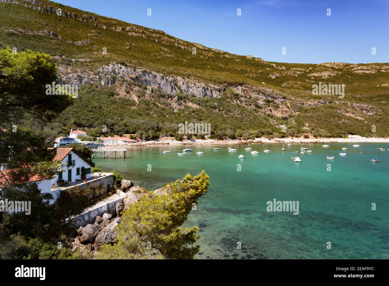 Portinho da Arrabida beach with anchored boats in crystalline water ...