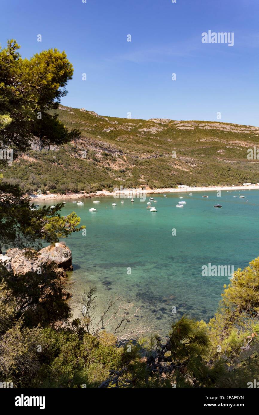 Portinho da Arrabida beach with anchored boats in crystalline water ...
