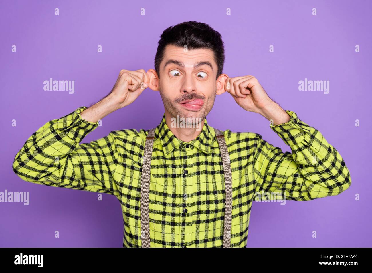 Photo of young funky funny humorous silly childish man stick tongue out ...