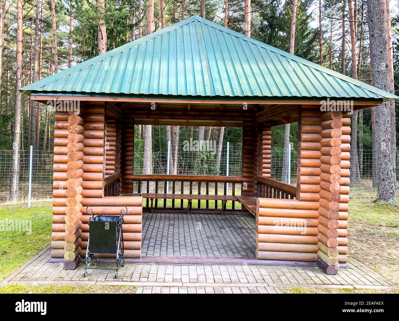 Large wooden gazebo on background of forest Stock Photo - Alamy