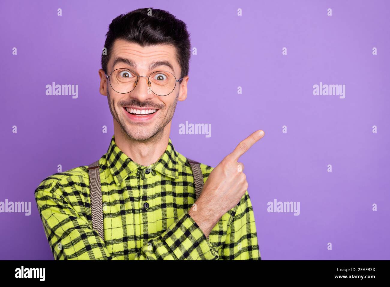 Portrait of young happy excited smiling positive gentleman point finger ...