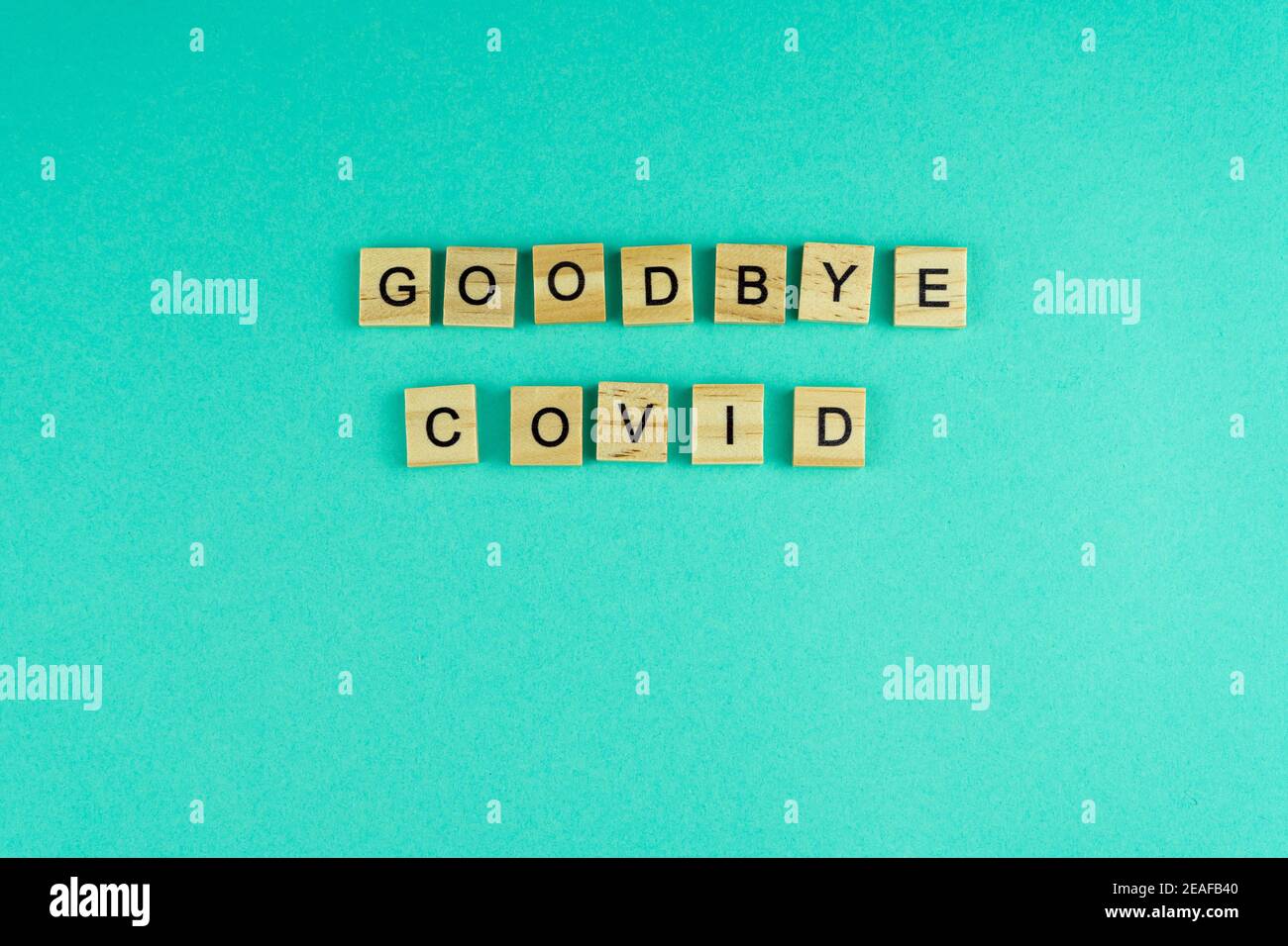 Word goodbye covid. The phrase is laid out in wooden letters. Top view ...