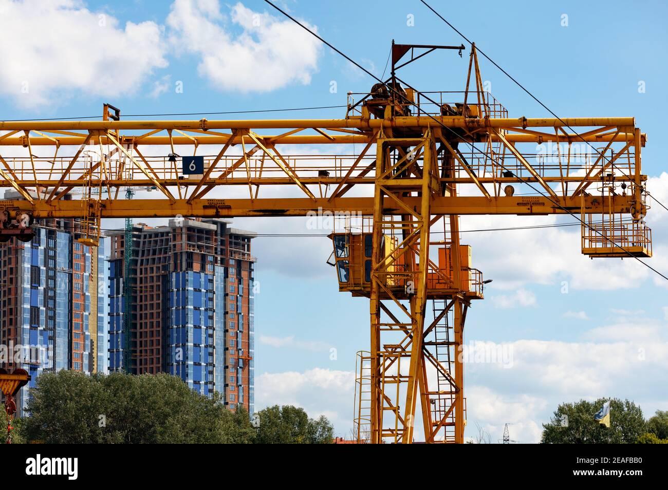 Metal construction crane for moving heavy loads against the background ...