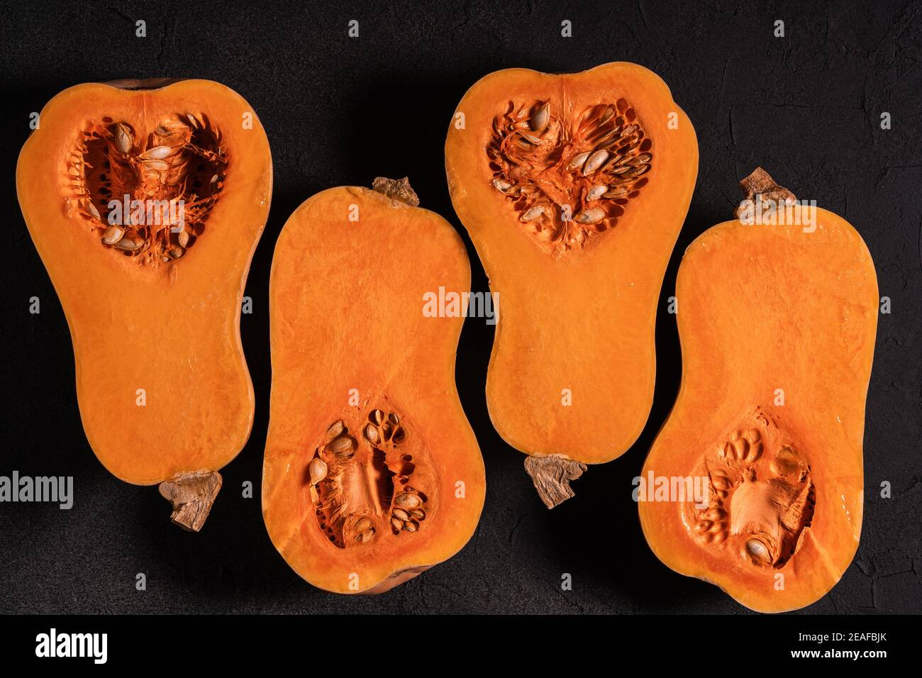 Raw organic butternut squash ready to cook on grey background viewed ...