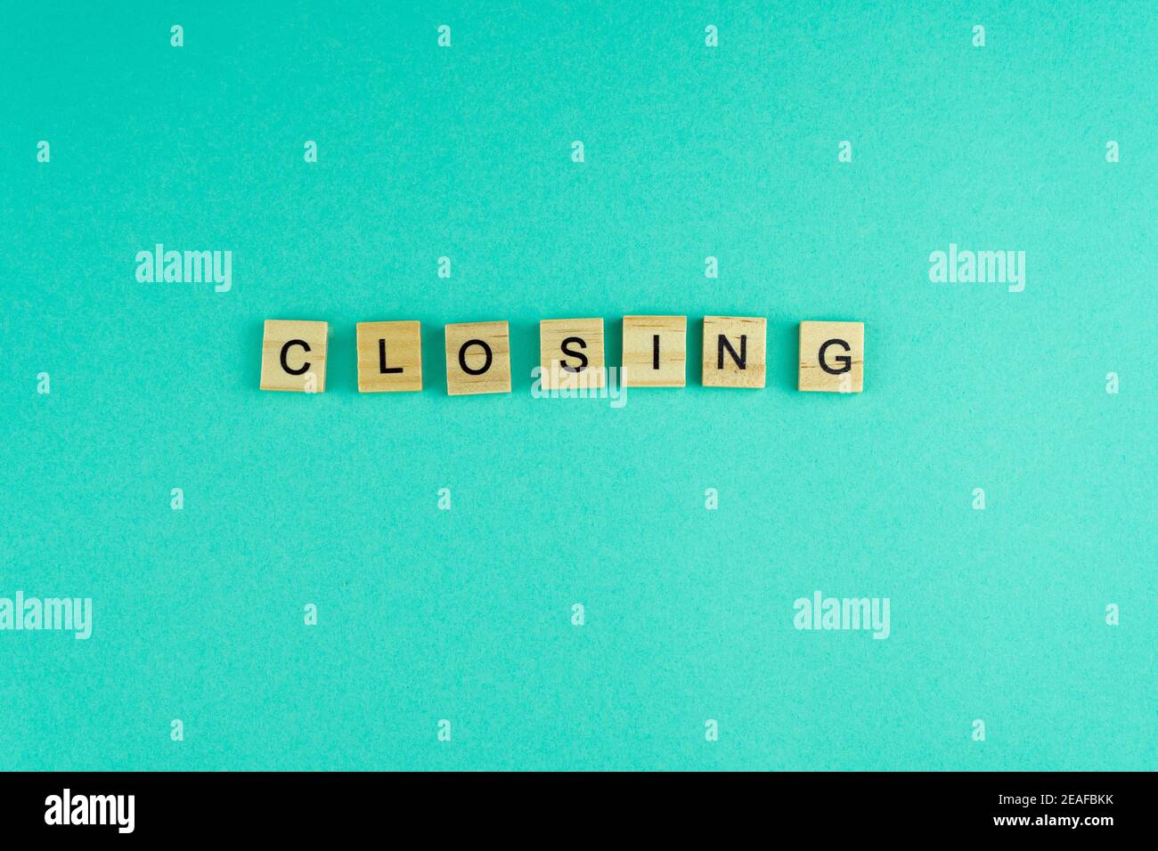 Word closing. The phrase is laid out in wooden letters. Top view ...