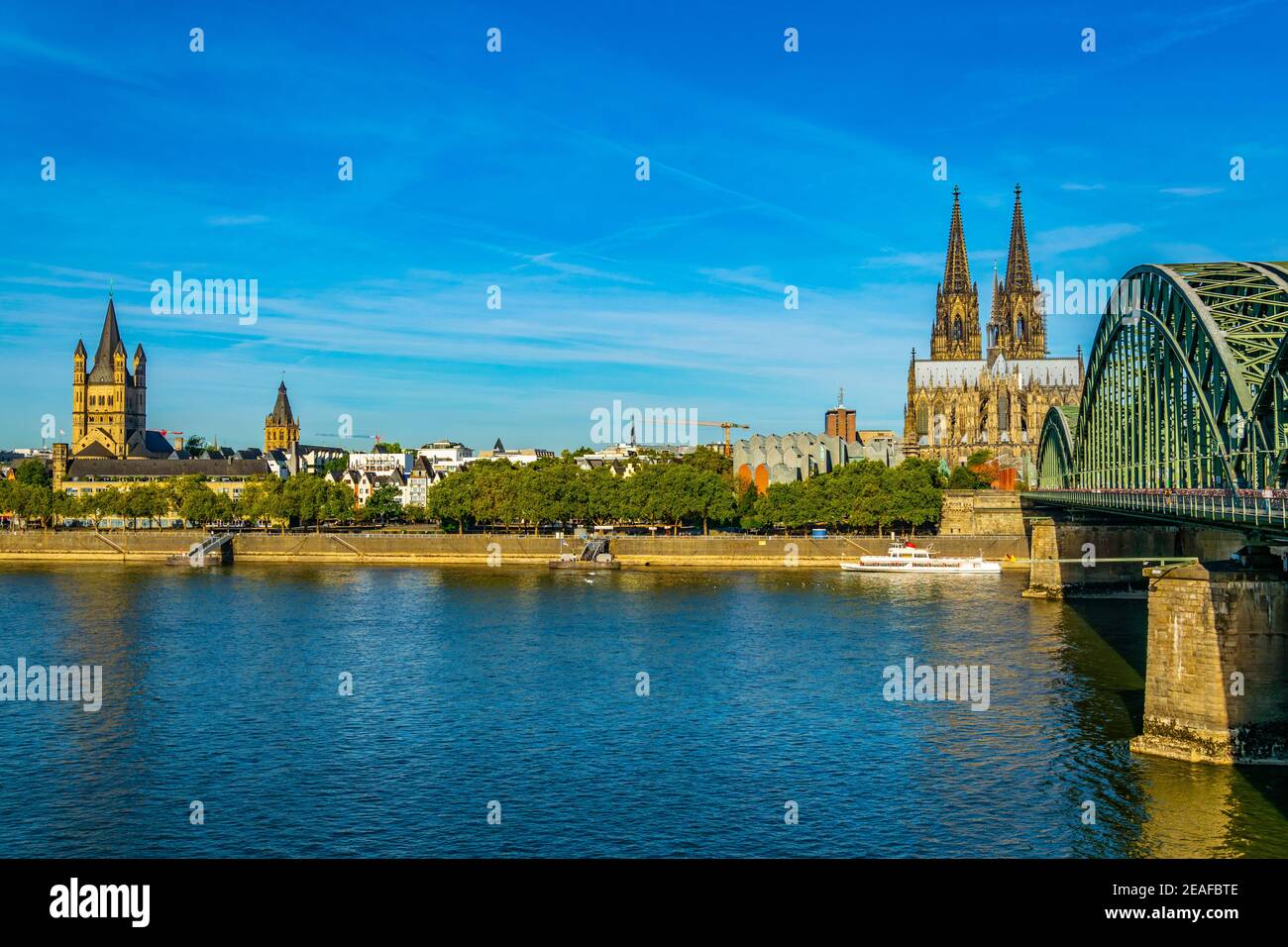 Cityscape of Cologne with Hohenzollern bridge, cathedral and Saint ...