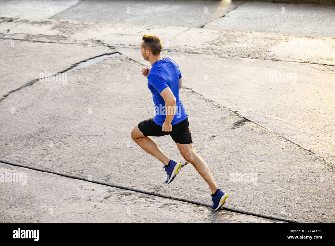 male runner to run morning jog along a concrete road Stock Photo - Alamy