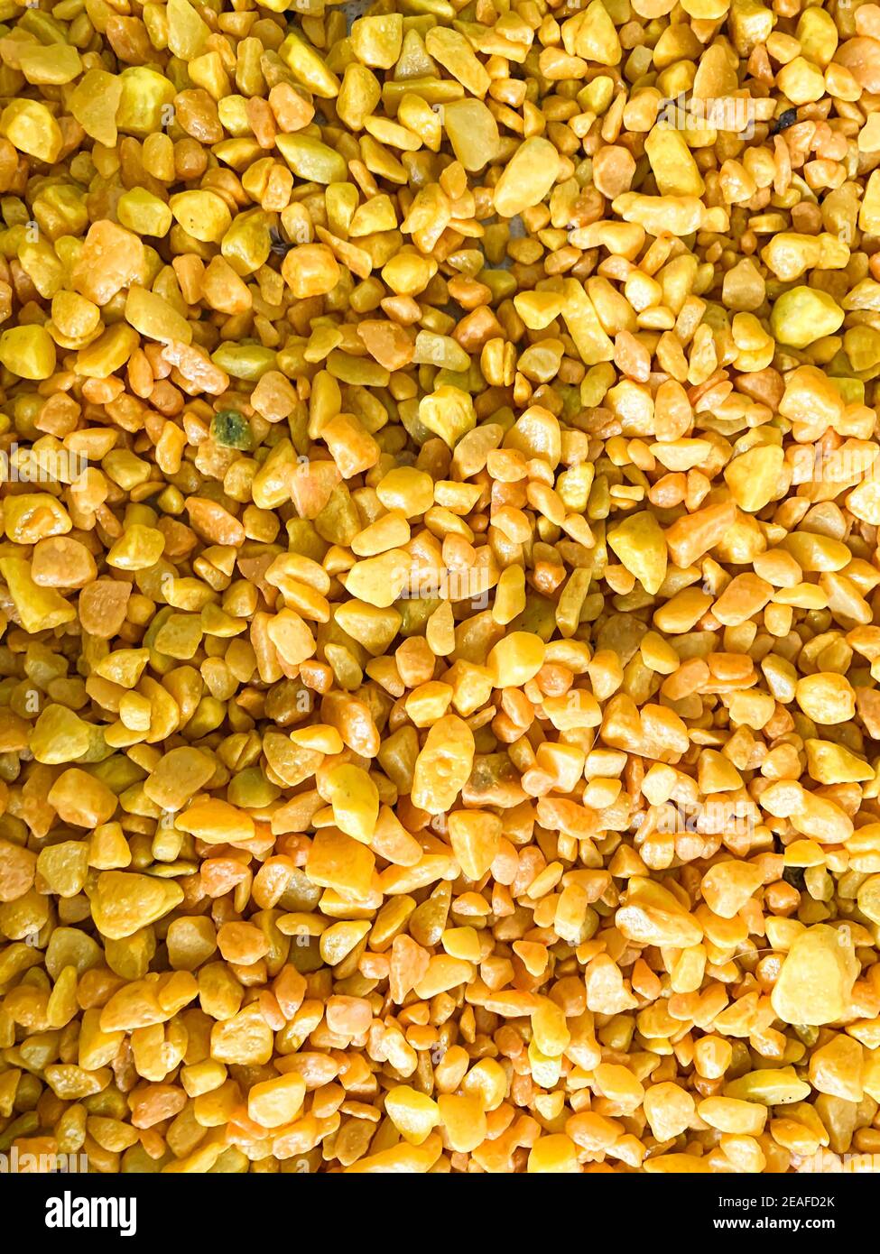 Background from decorative yellow small pebbles Stock Photo - Alamy