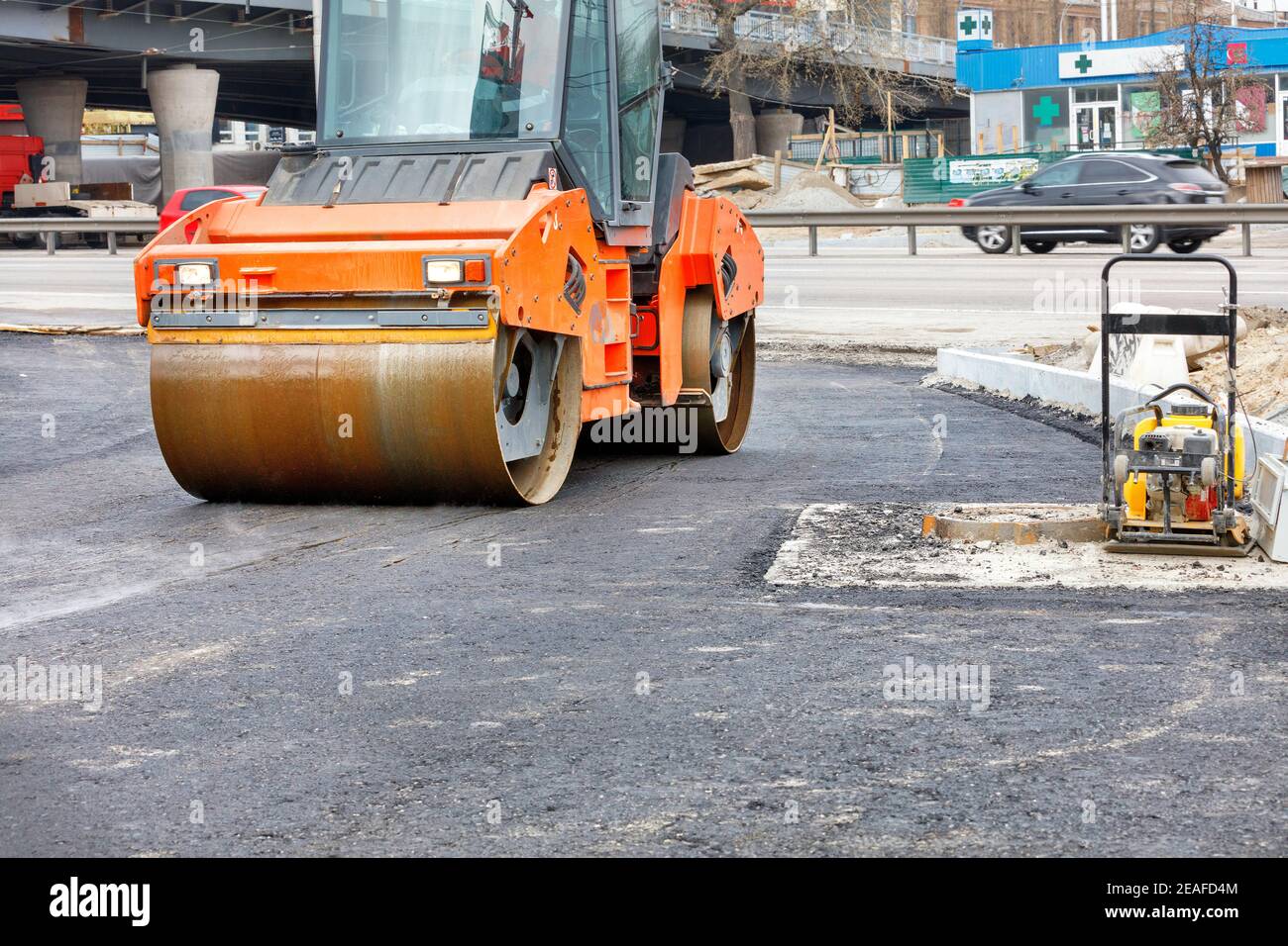 A heavy road vibratory roller and a petrol vibratory compactor plate ...