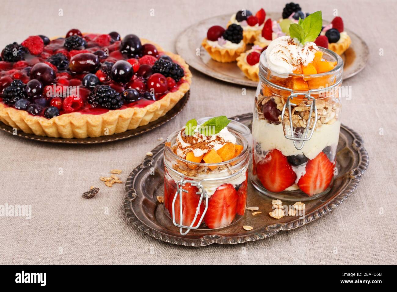 Layer fruit dessert in glass container. Summer party Stock Photo - Alamy