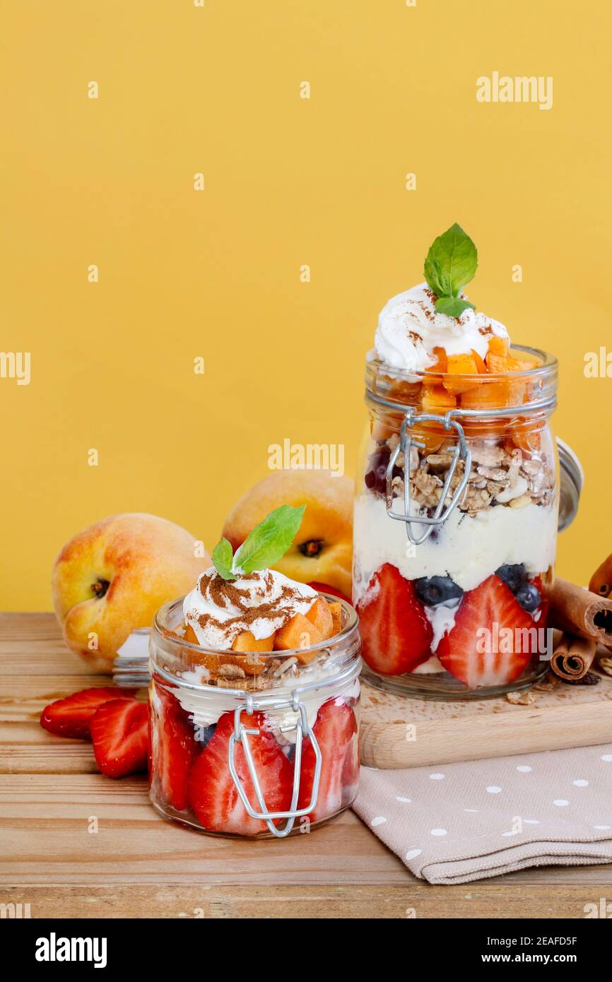 Layer fruit dessert in glass container. Summer party Stock Photo - Alamy
