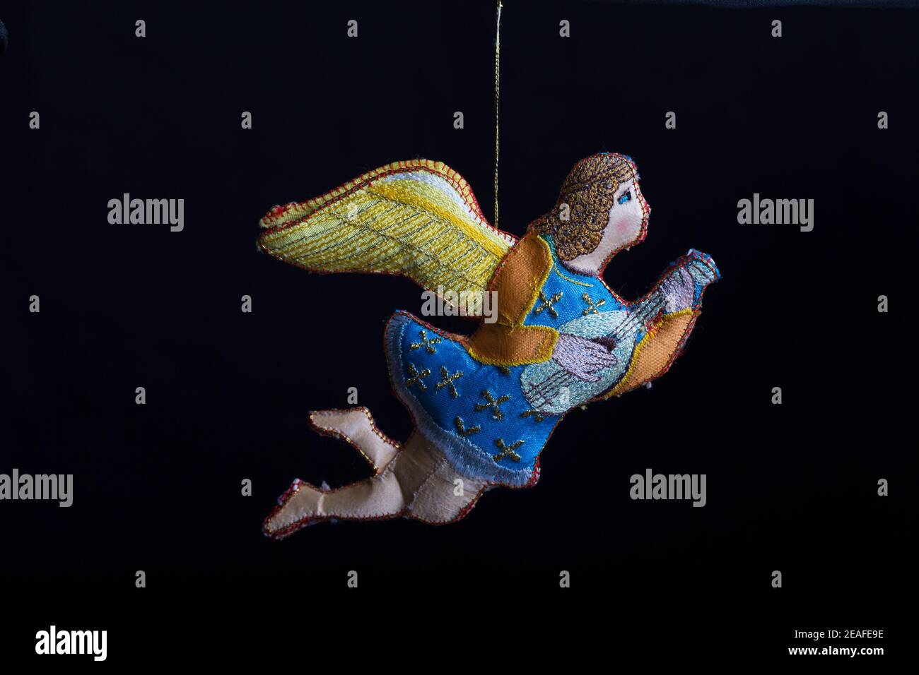 Christmas decorations on string angels with black background Stock ...