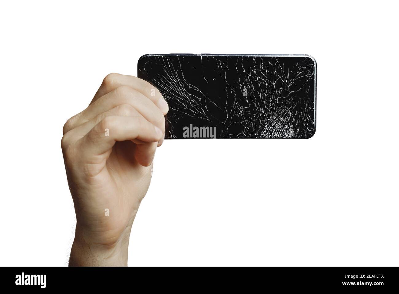 A man's hand holds a black phone with a broken screen. Isolated on a ...