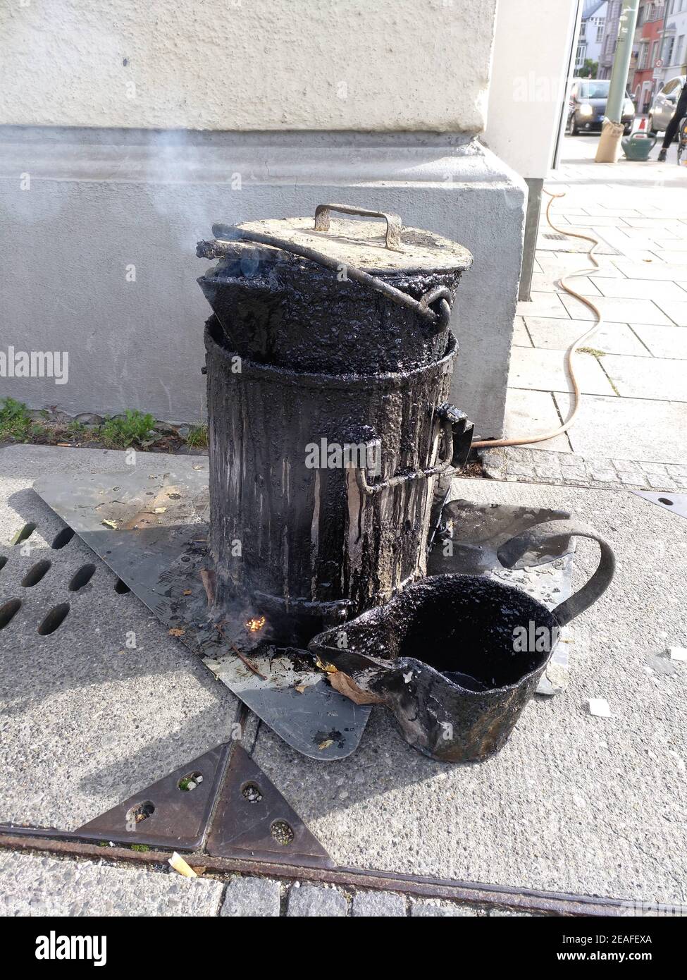Asphalt melting in a electric pot on roadside Stock Photo - Alamy