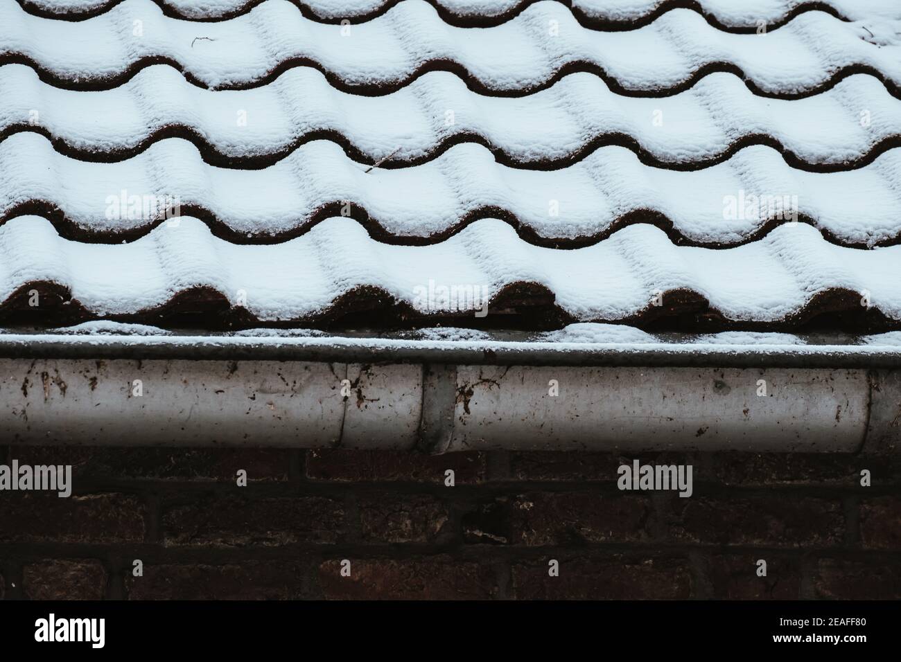 Roof tiles covered by snow in winter Stock Photo - Alamy