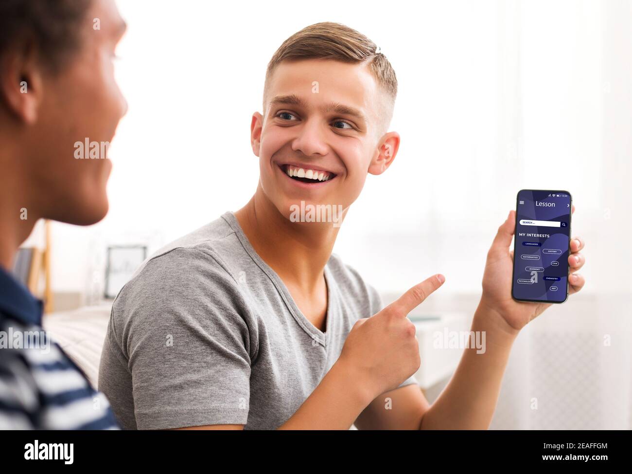 Cheerful Guy Showing Smartphone With Online Learning App On Screen To ...