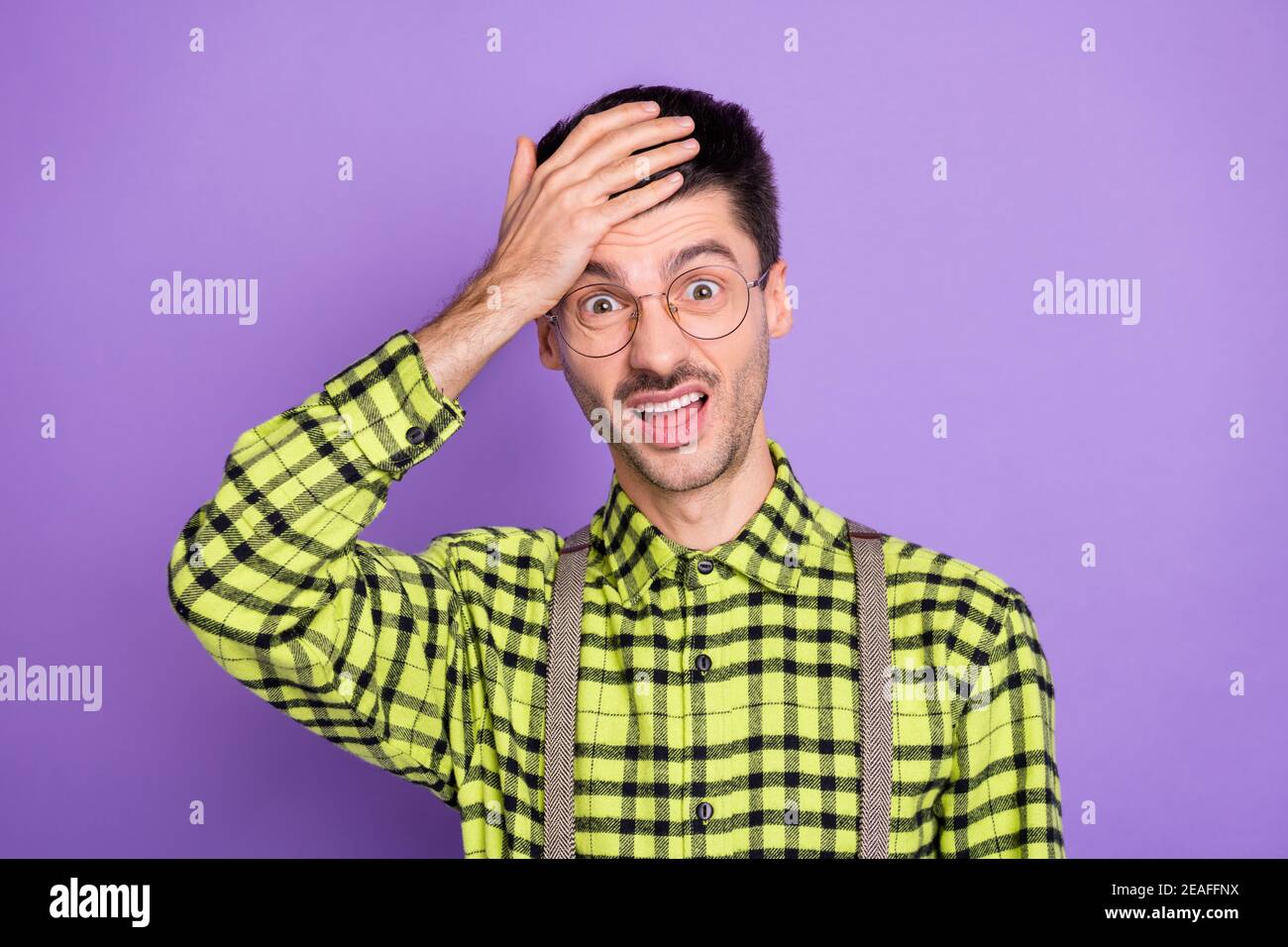 Photo portrait of disappointed guy facepalming isolated on vivid violet ...