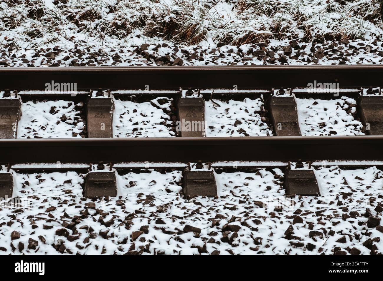 Rails of a train covered by snow in winter Stock Photo - Alamy