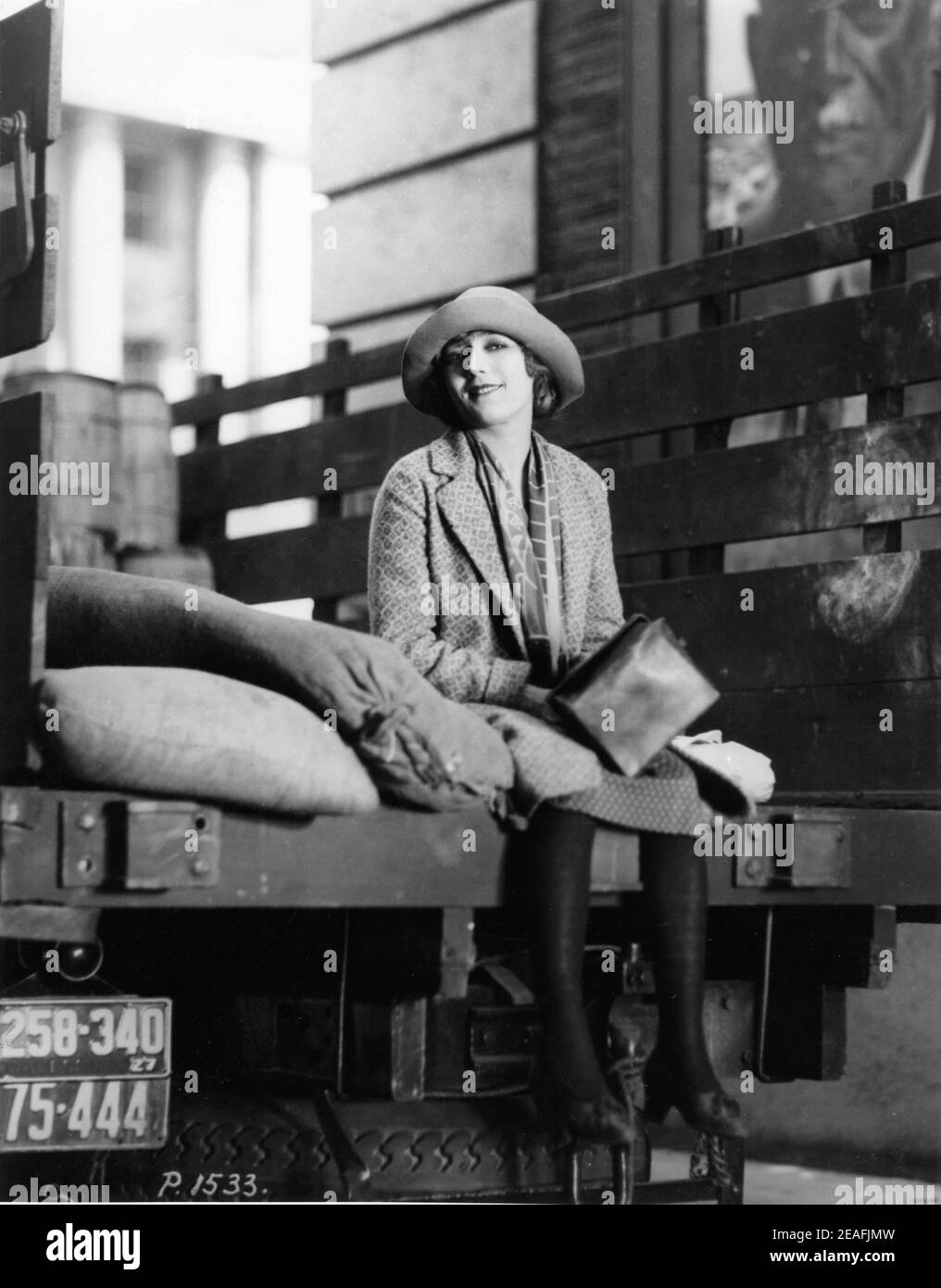 MARY PICKFORD on set candid portrait sitting on back of truck during ...