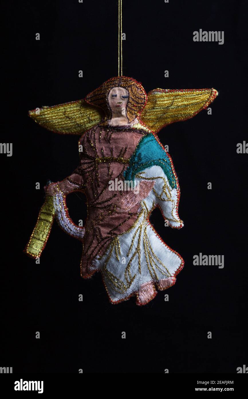 Christmas decorations on string angels with black background Stock ...