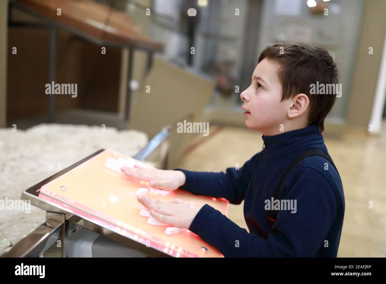 Portrait of child controls exhibition in museum Stock Photo - Alamy