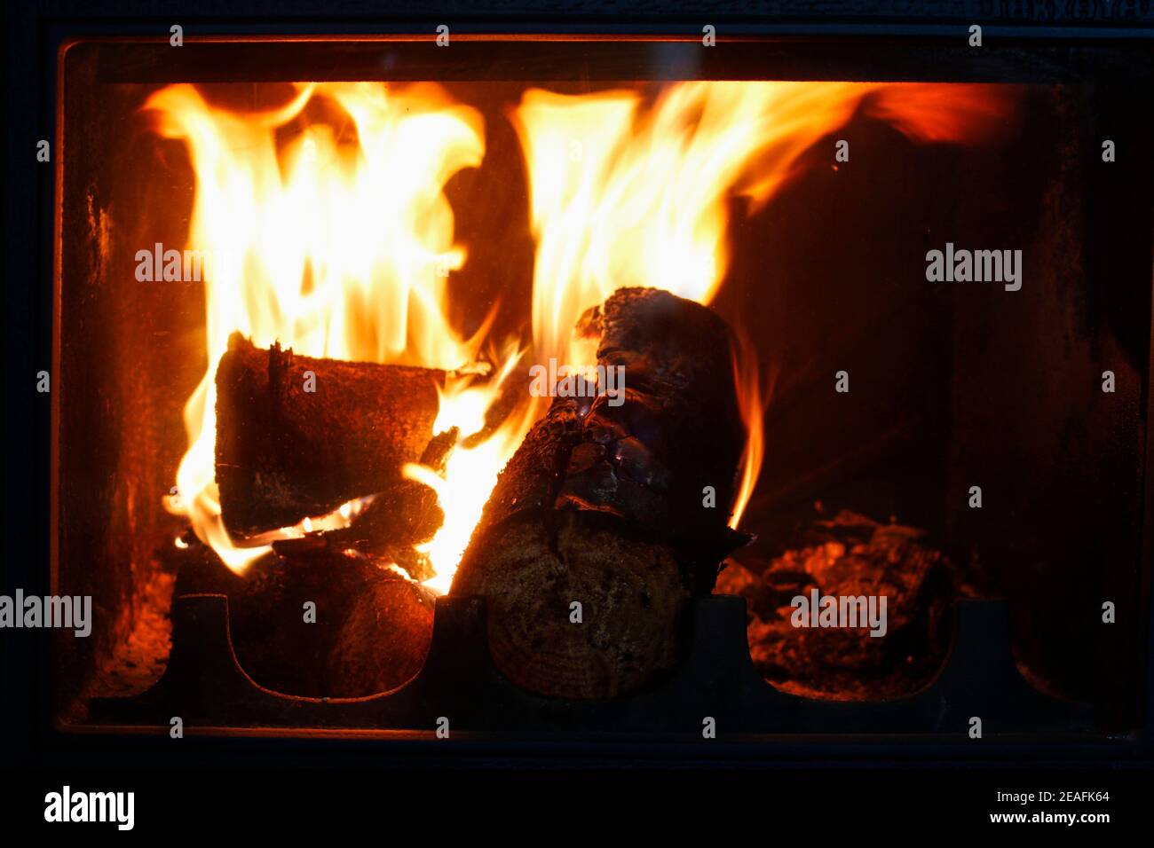 Burning wood in the fireplace. Relax time Stock Photo - Alamy