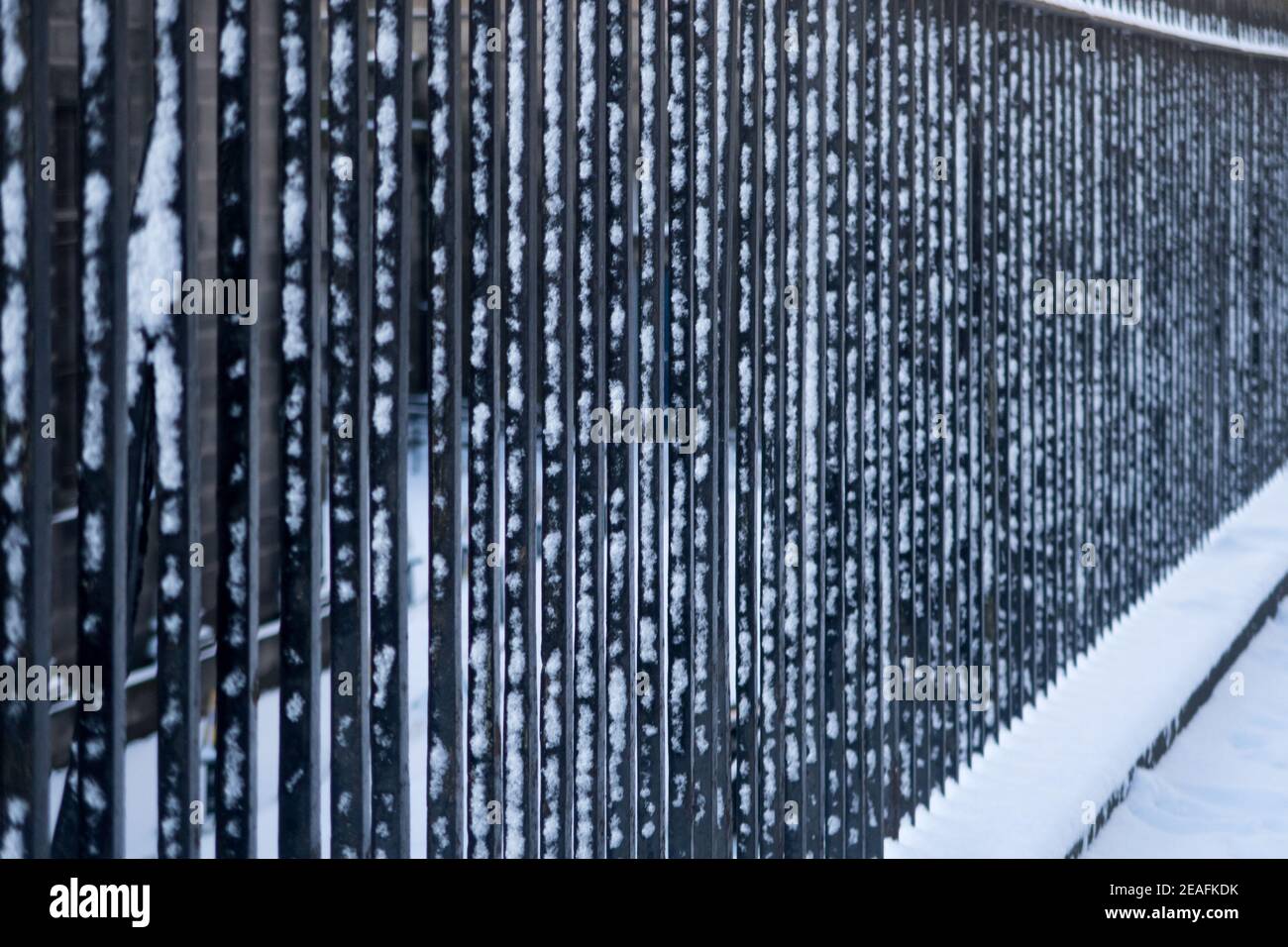 A metal fence covered in snow Stock Photo - Alamy