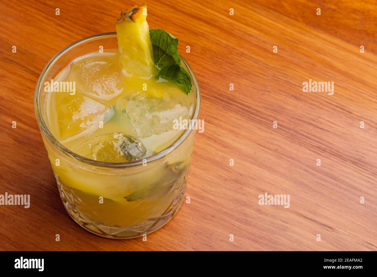 Closeup shot of a glass of alcoholic cocktail with fruit mixology on a ...