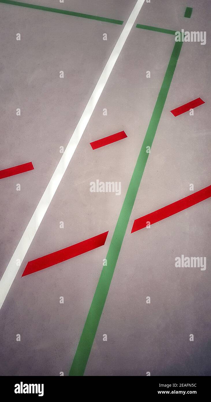 Vertical high angle shot of green, white and red lines on the ground ...