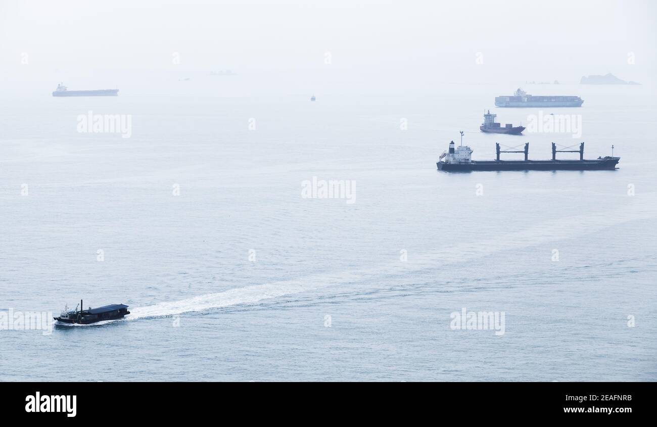 Industrial cargo ships are in Japan Sea at daytime. Busan bay aerial ...