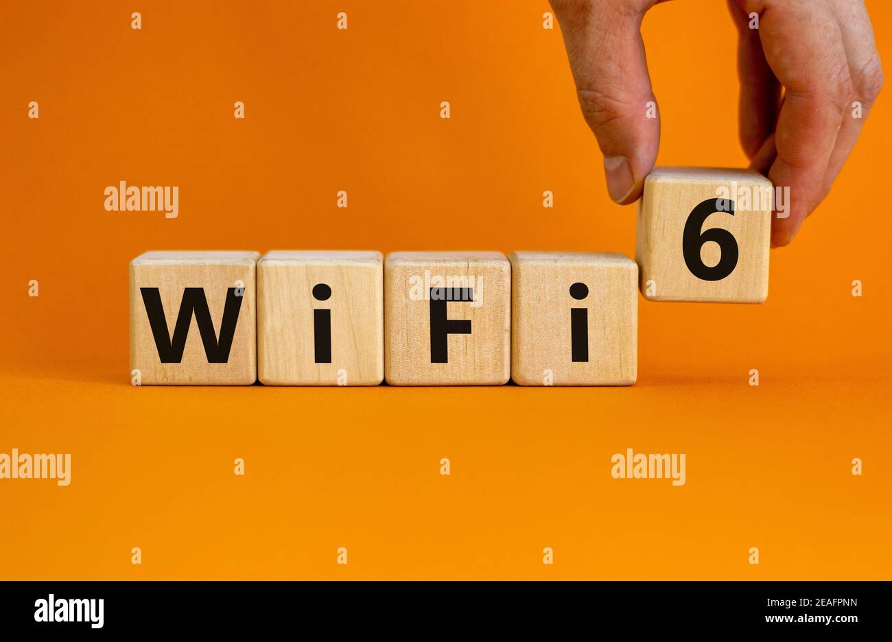 WiFi 6 symbol. Businessman holds a wooden cube with words WiFi 6 ...