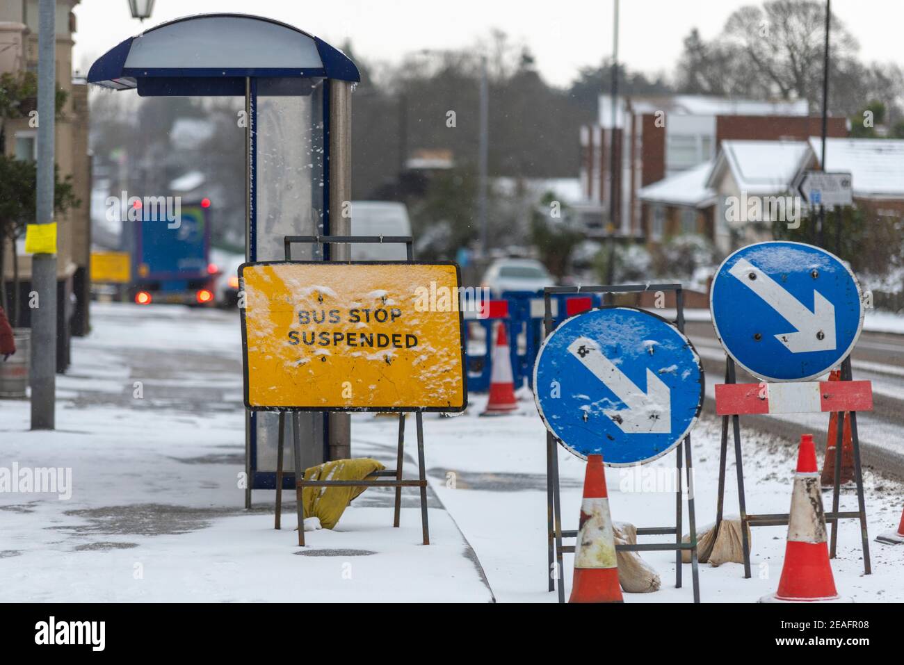 Bus stop suspended sign in Southend on Sea, Essex, UK, with snow from ...