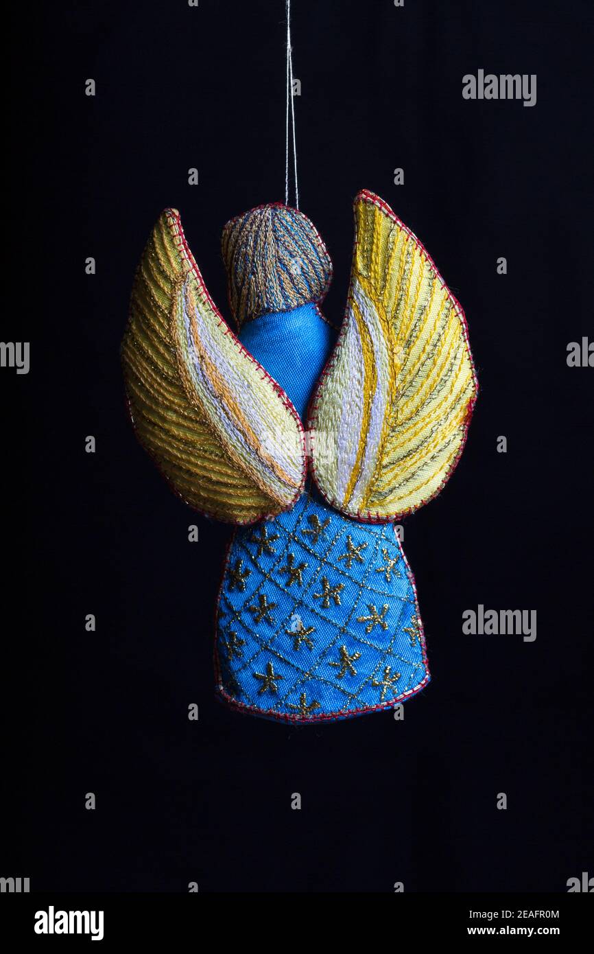 Christmas decorations on string angels with black background Stock ...