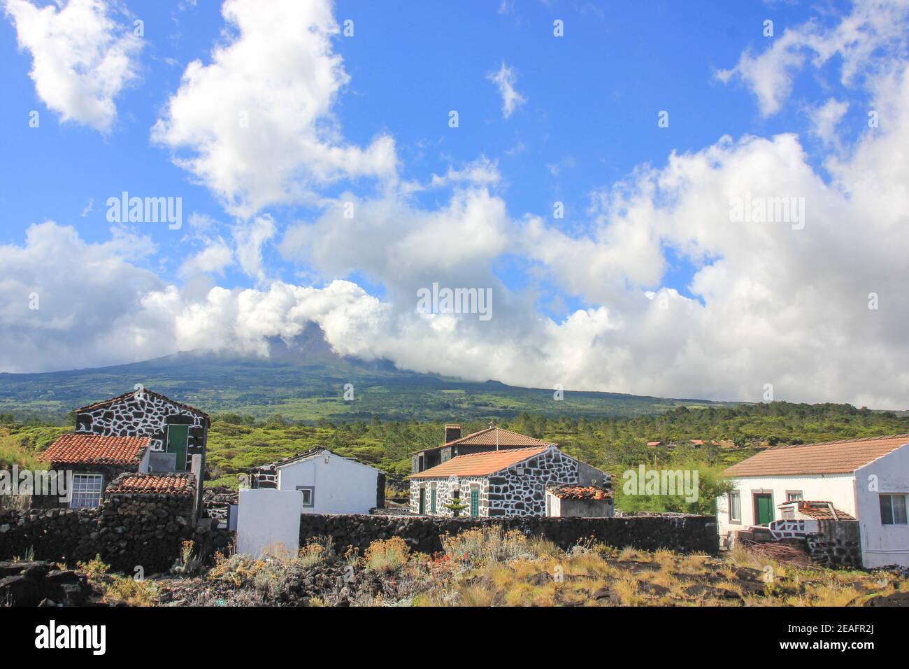 Pico island, view to the mountain with clouds, houses, village, Azores ...